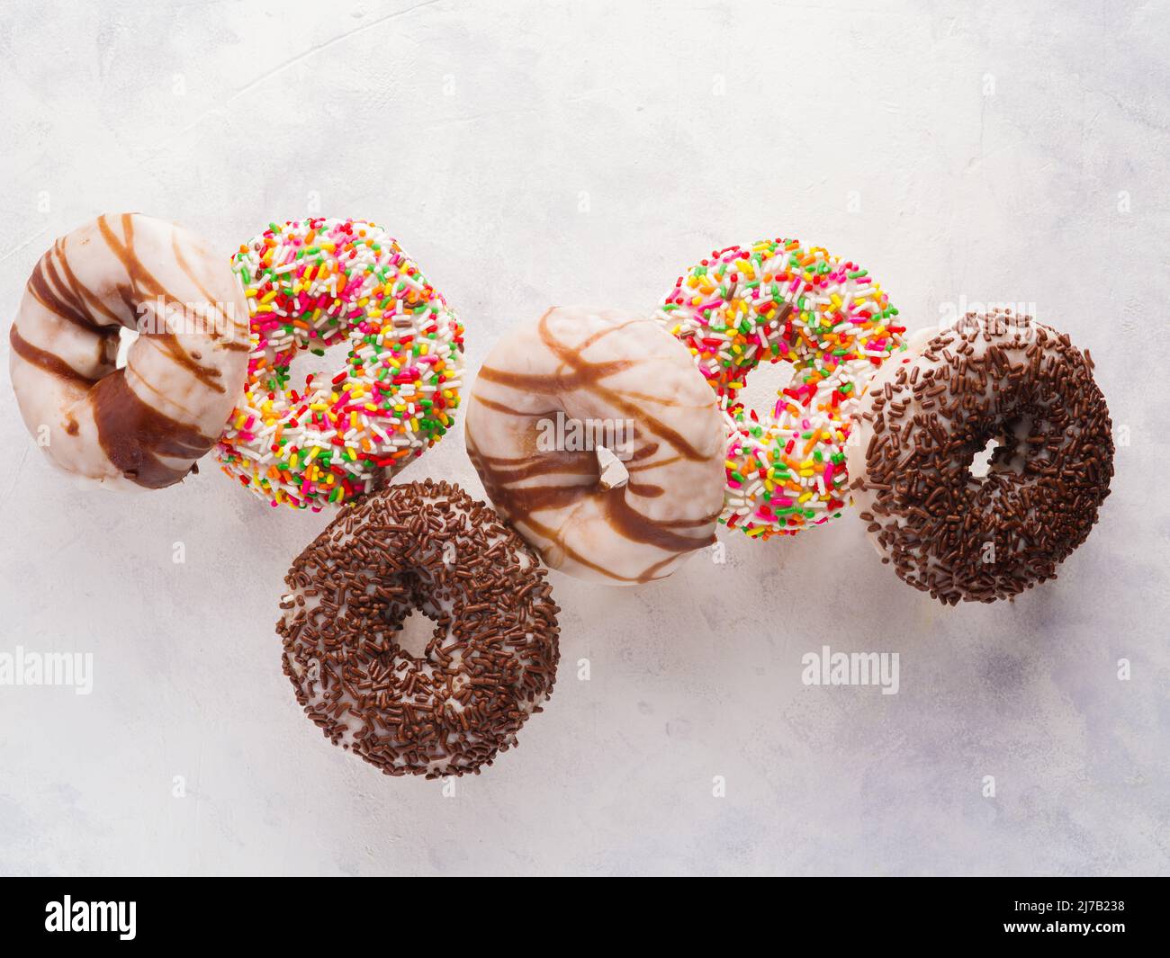 Multi-colored sweet donuts covered with sugar icing, confectionery ...