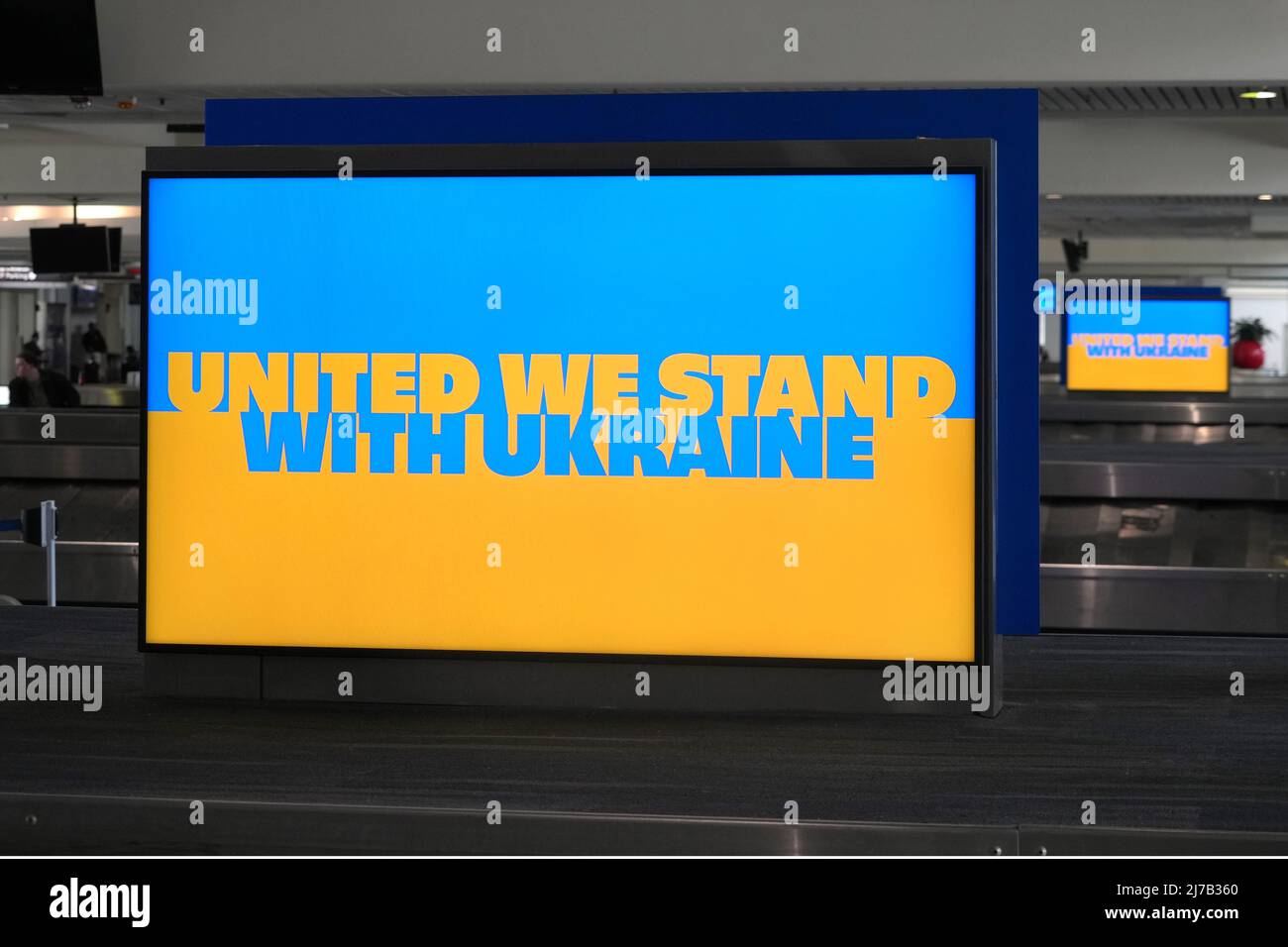 A United Stand with Ukraine message with a yellow and blue background ...