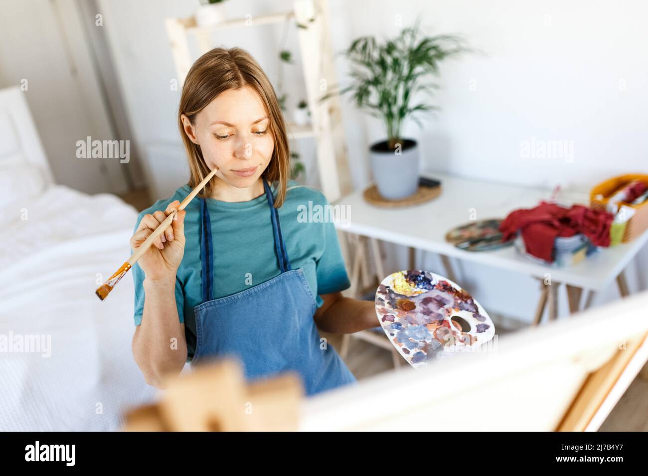 Woman artist holding paintbrush.Creative woman enjoying painting.Young ...