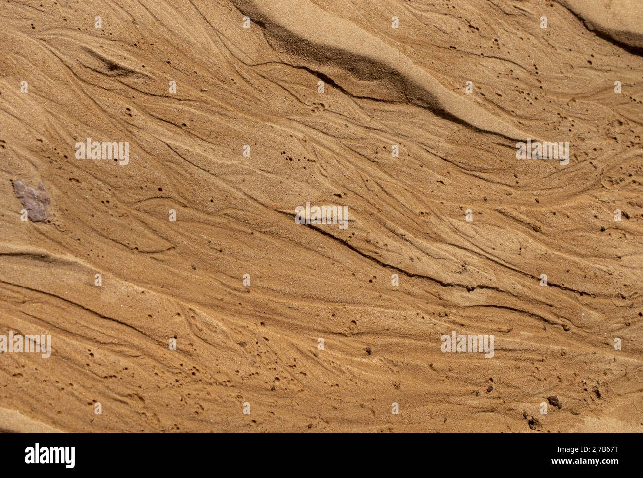 Eye appealing pattern and designs in the yellow sand Stock Photo - Alamy