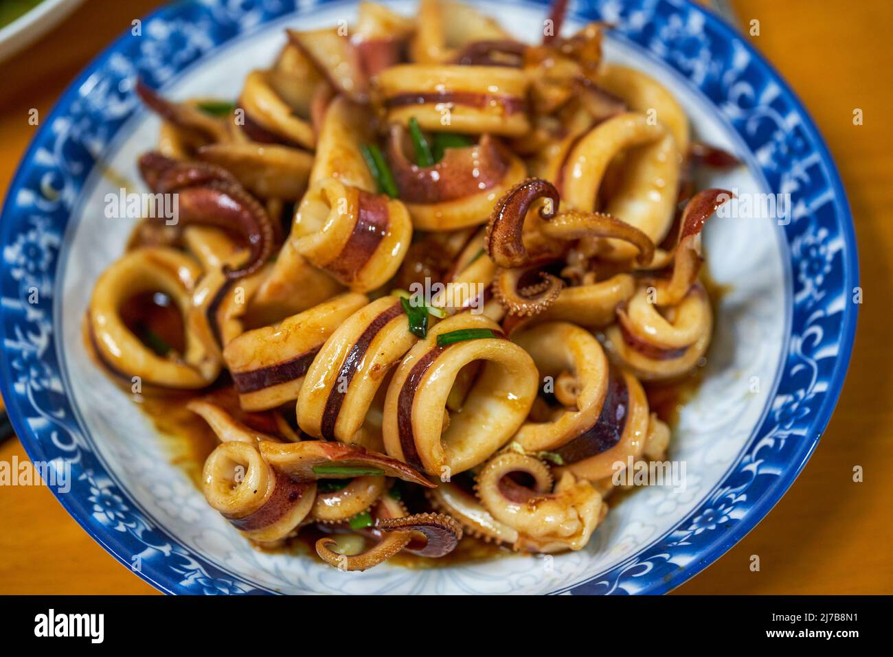 A delicious Chinese dish with fried fresh squid in sauce Stock Photo ...