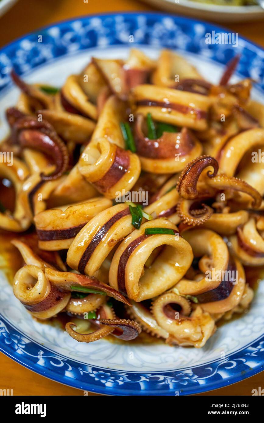 A delicious Chinese dish with fried fresh squid in sauce Stock Photo ...