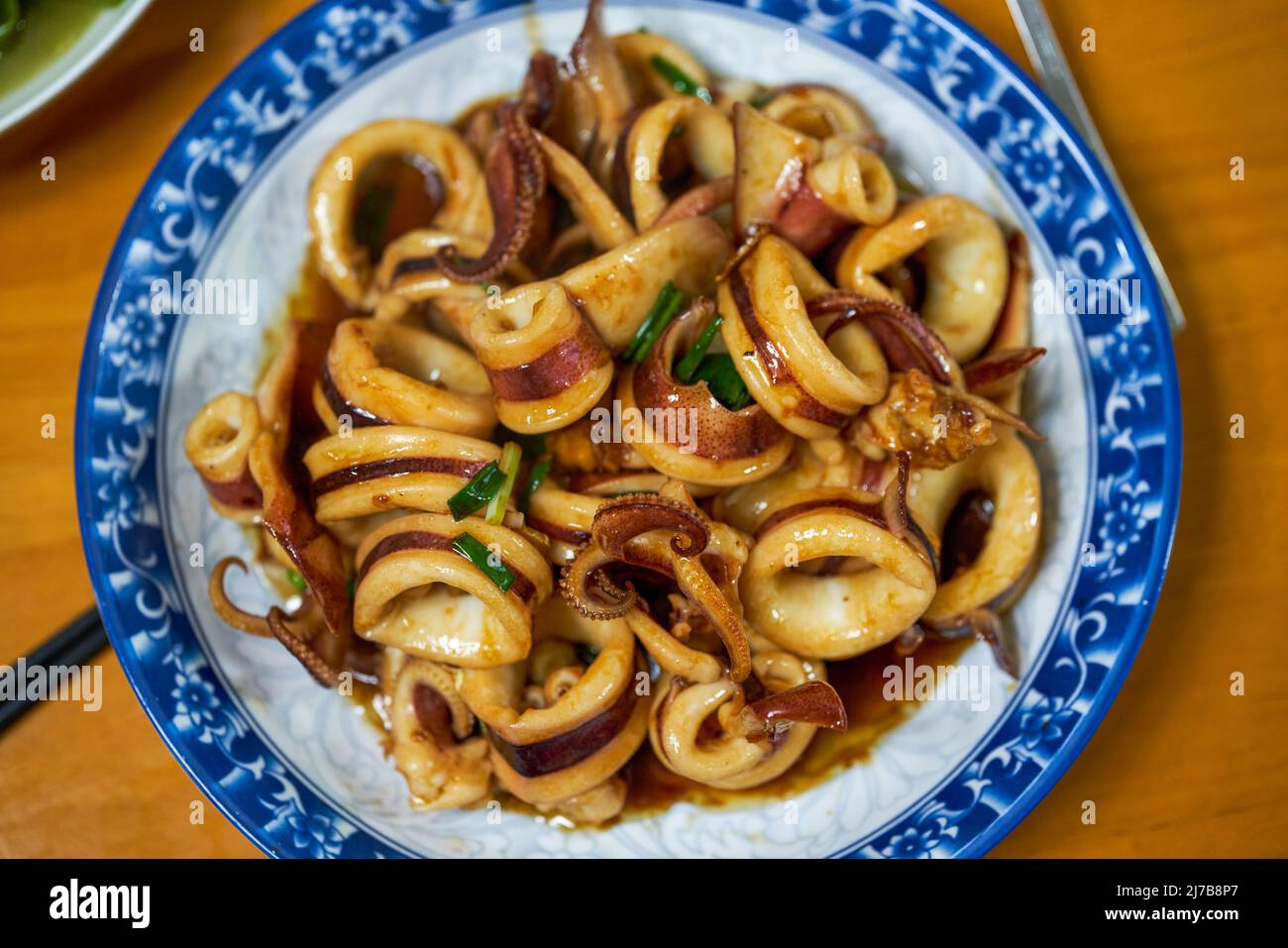 A delicious Chinese dish with fried fresh squid in sauce Stock Photo ...