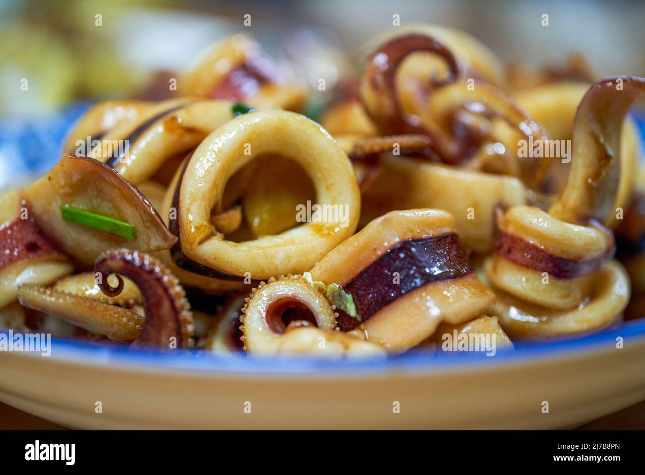 A delicious Chinese dish with fried fresh squid in sauce Stock Photo ...