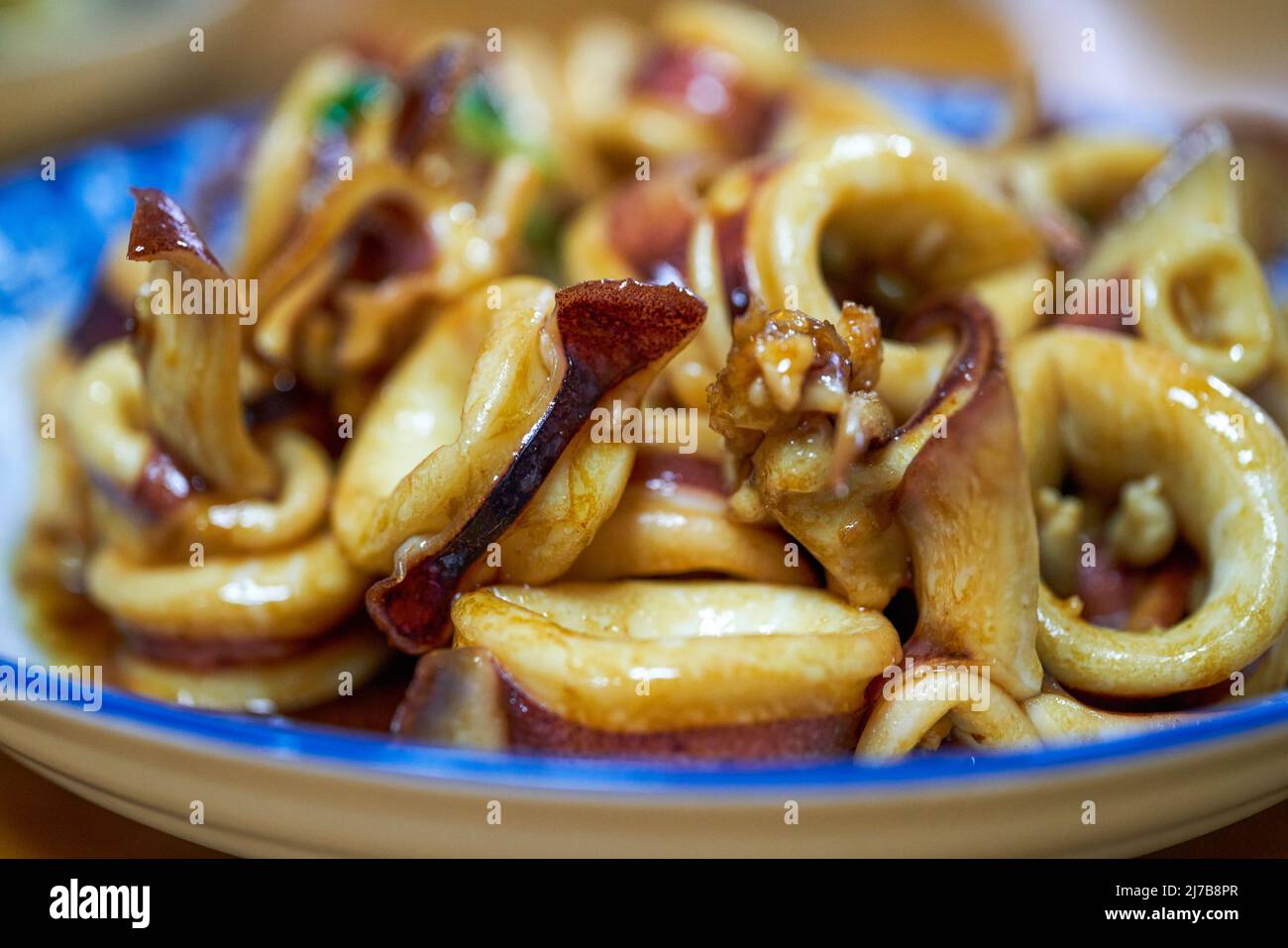 A delicious Chinese dish with fried fresh squid in sauce Stock Photo ...