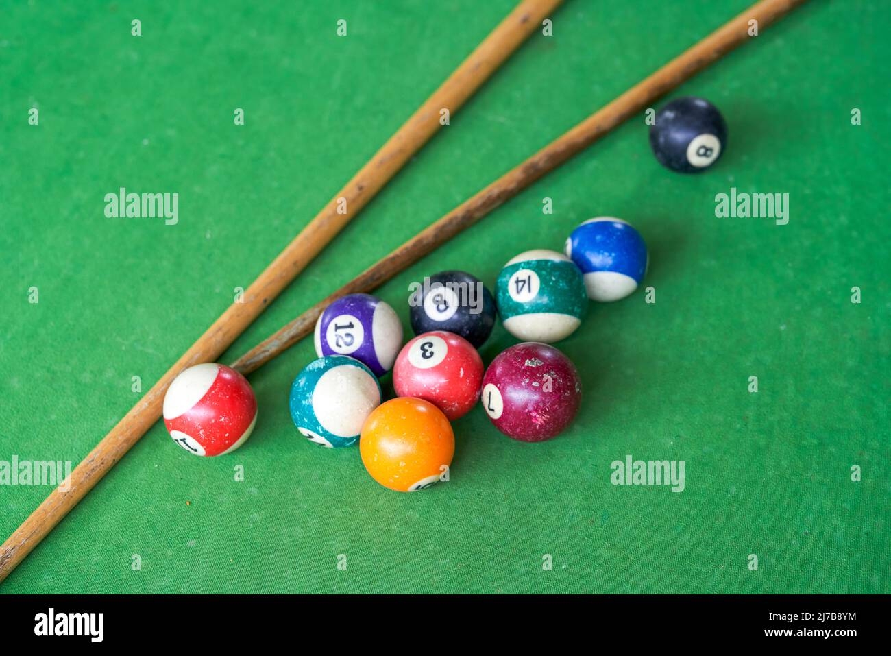 Billiards and pool cues on the pool table Stock Photo - Alamy