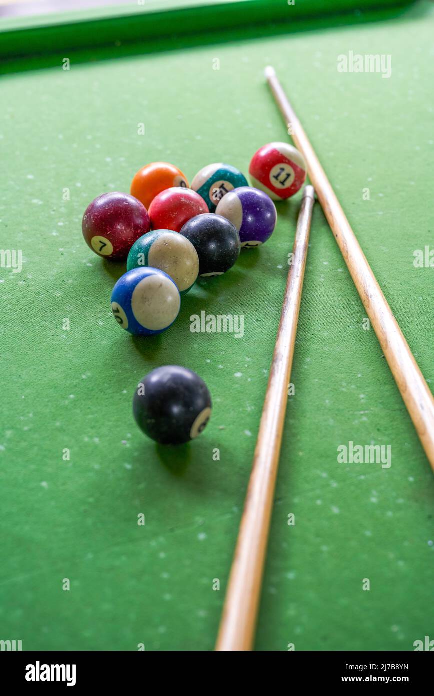 Billiards and pool cues on the pool table Stock Photo - Alamy