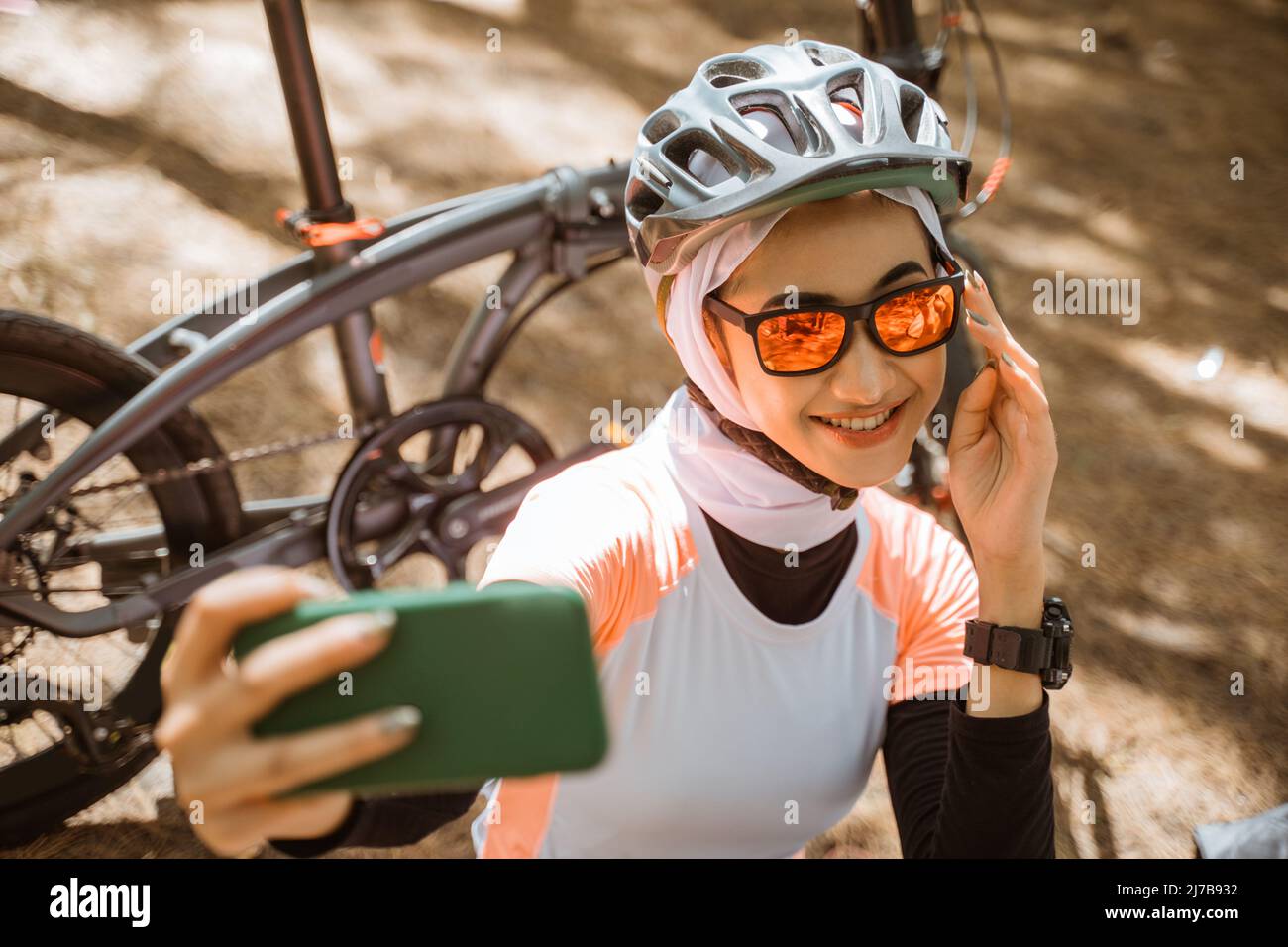 veiled girl in sunglasses posing for selfie in smartphone photo Stock ...