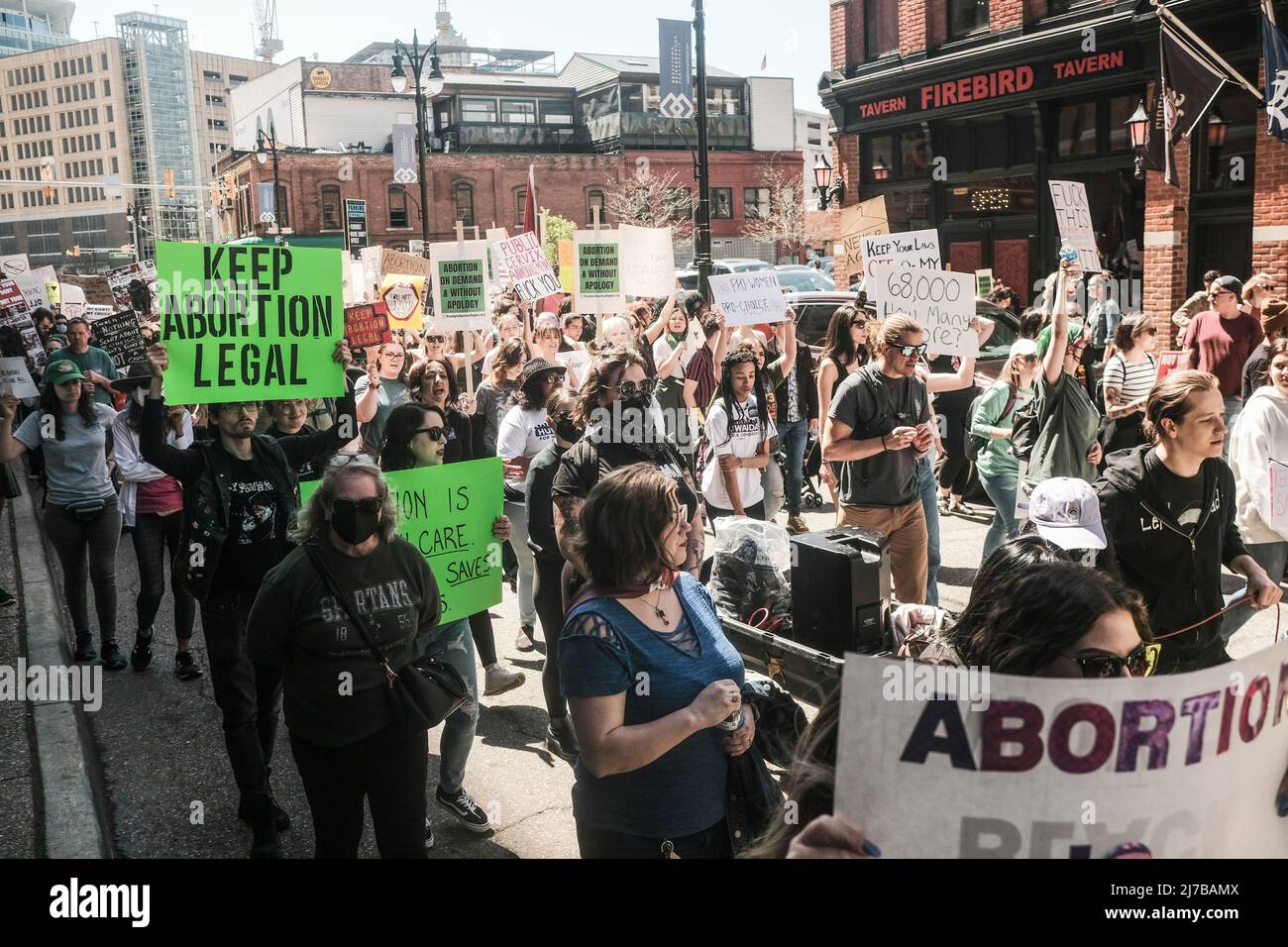 Protesters hold placards, chant, and march through downtown Detroit in ...