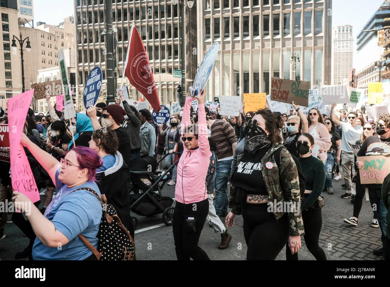 Protesters hold placards, chant, and march through downtown Detroit in ...