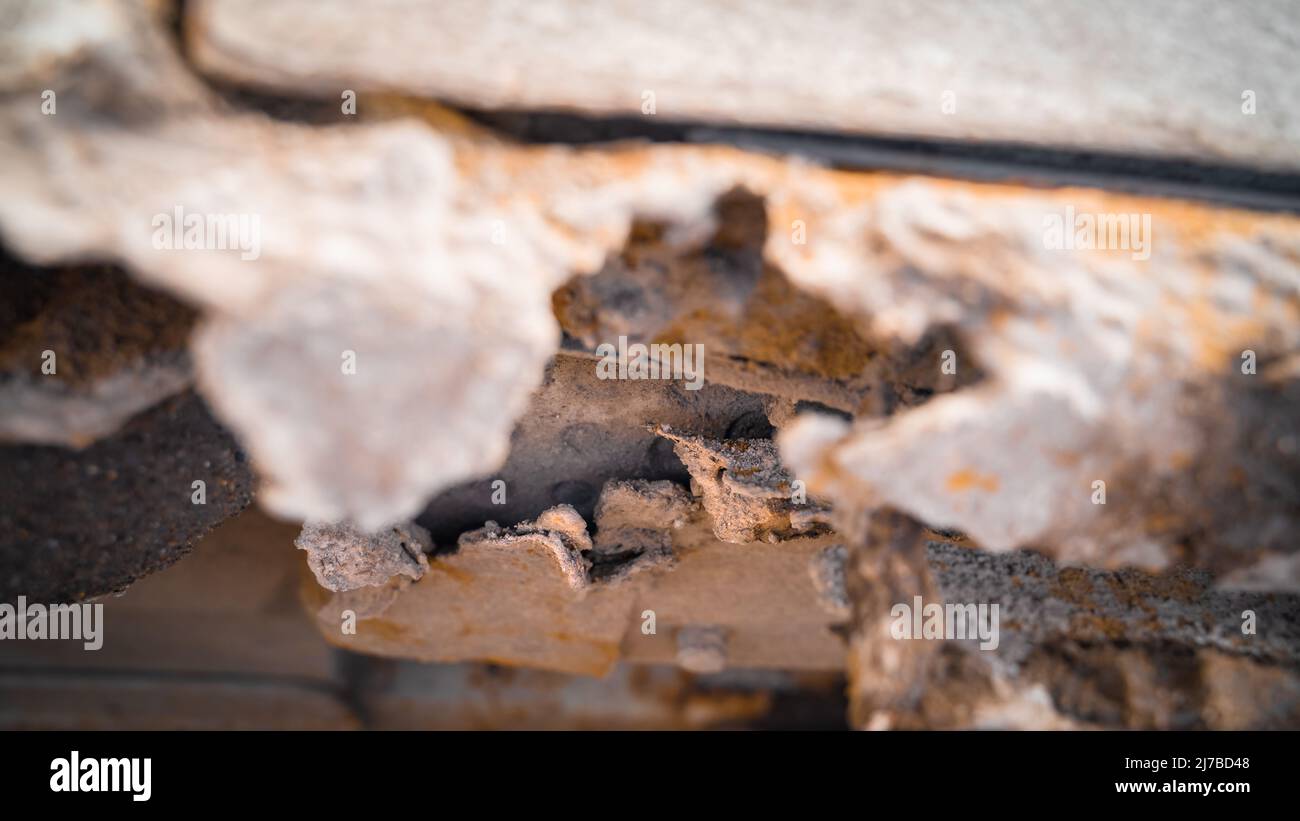 Rusted white car sills close-up. The effect of reagents in winter on an ...