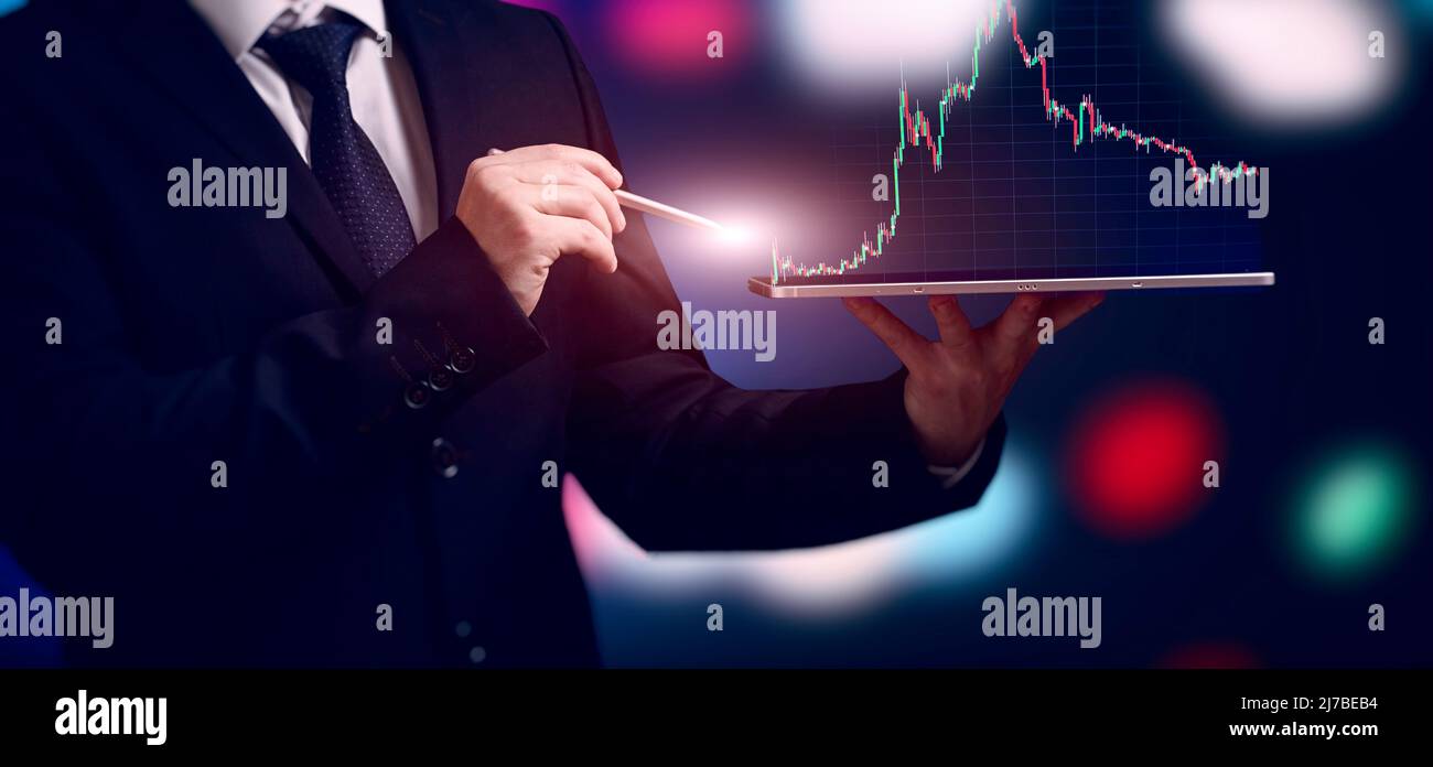 Businessman holding stock tablet ,virtual technical investment graph ...