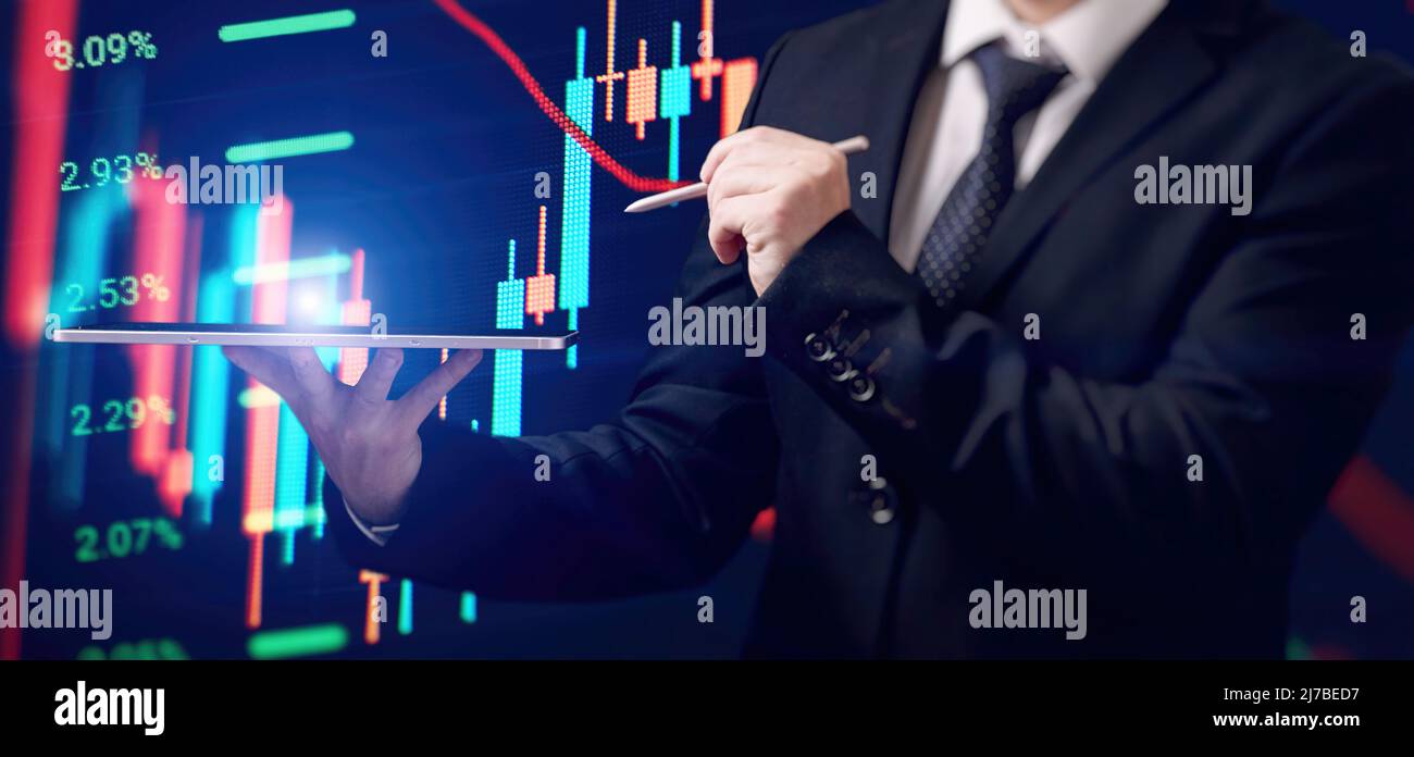 Businessman holding stock tablet ,virtual technical investment graph ...