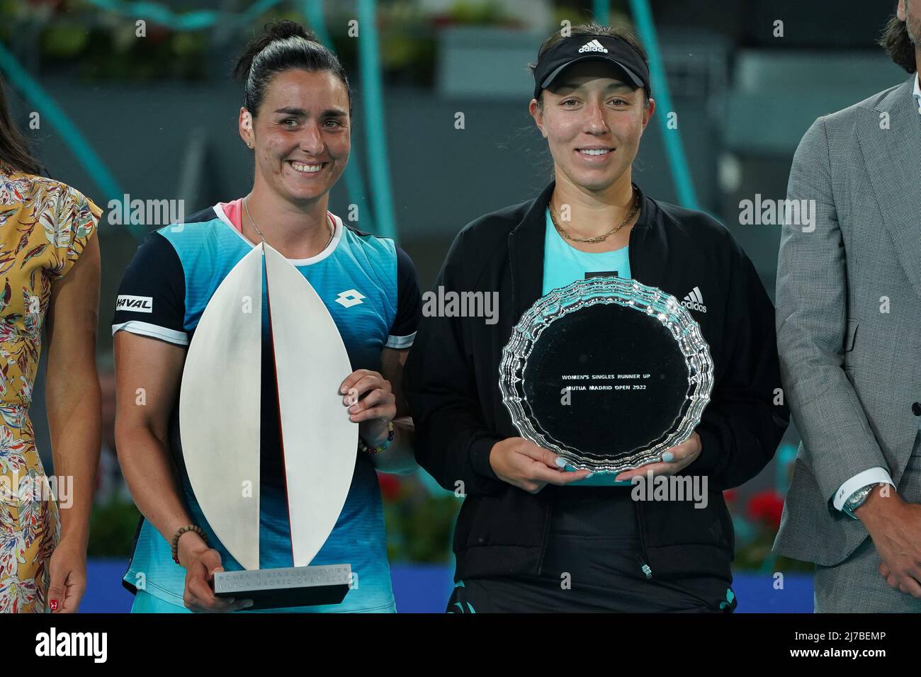 Ons Jabeur (L) of Tunisia celebrates with a trophy and Jessica Pegula ...