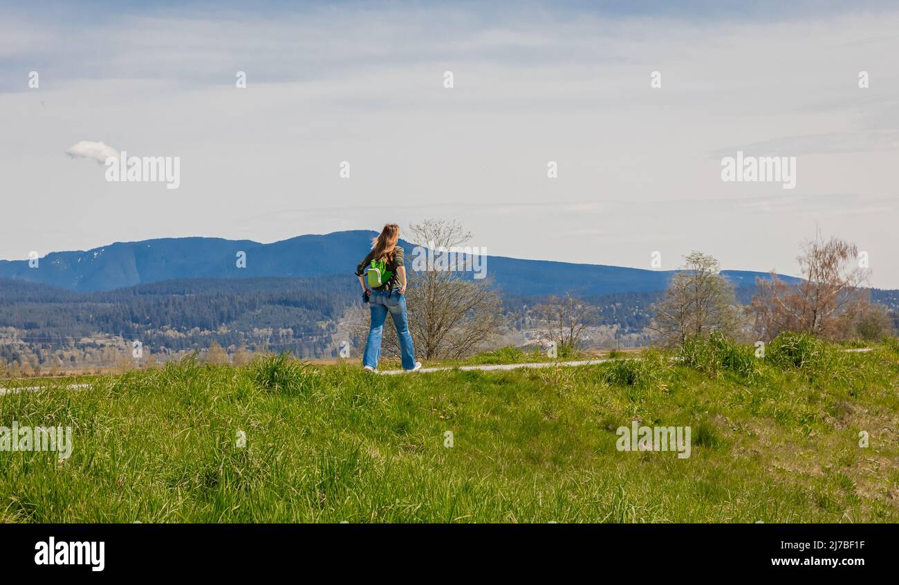 Woman walking in spring forest nature path walk on trail woods ...