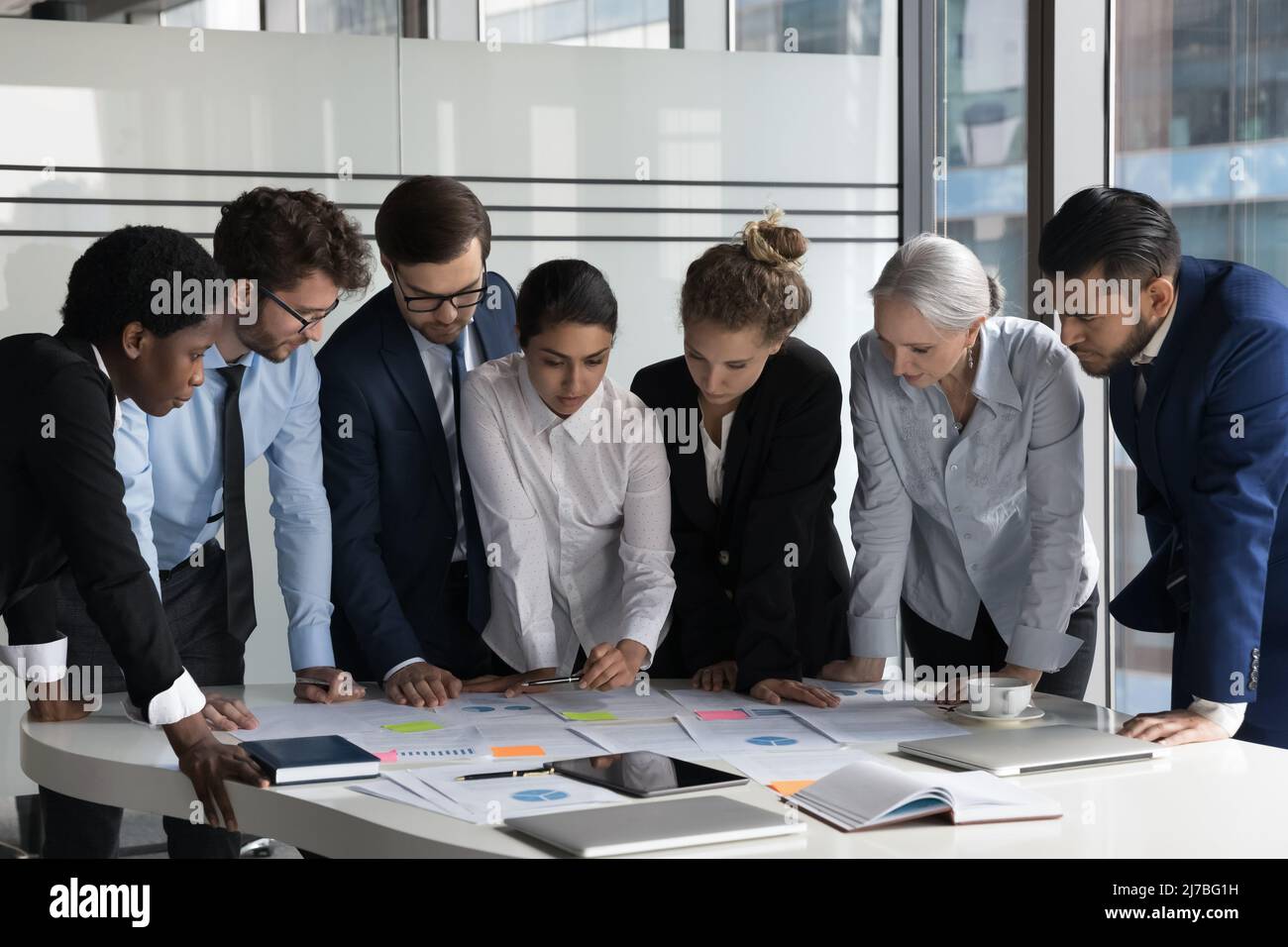 Multiethnic business team meeting over project marketing reports Stock ...
