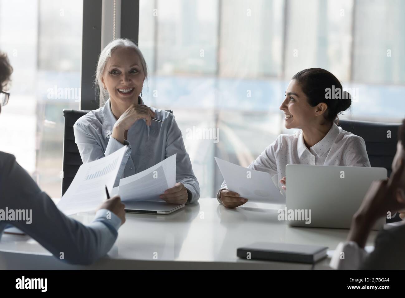 Successful diverse business team cooperating on project Stock Photo - Alamy