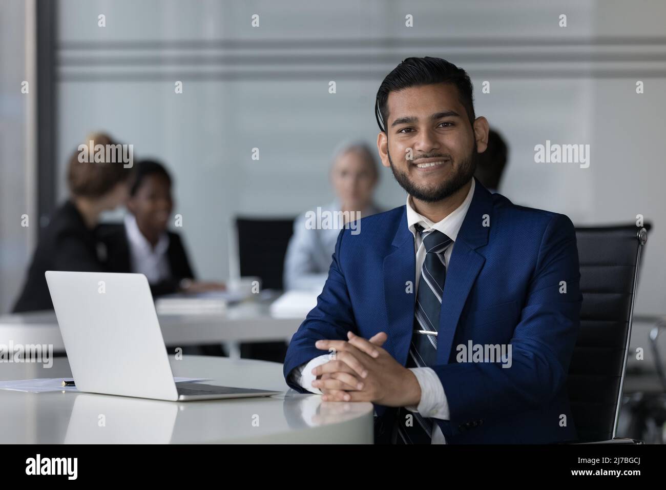 Happy cheerful Indian professional guy head shot portrait at laptop ...