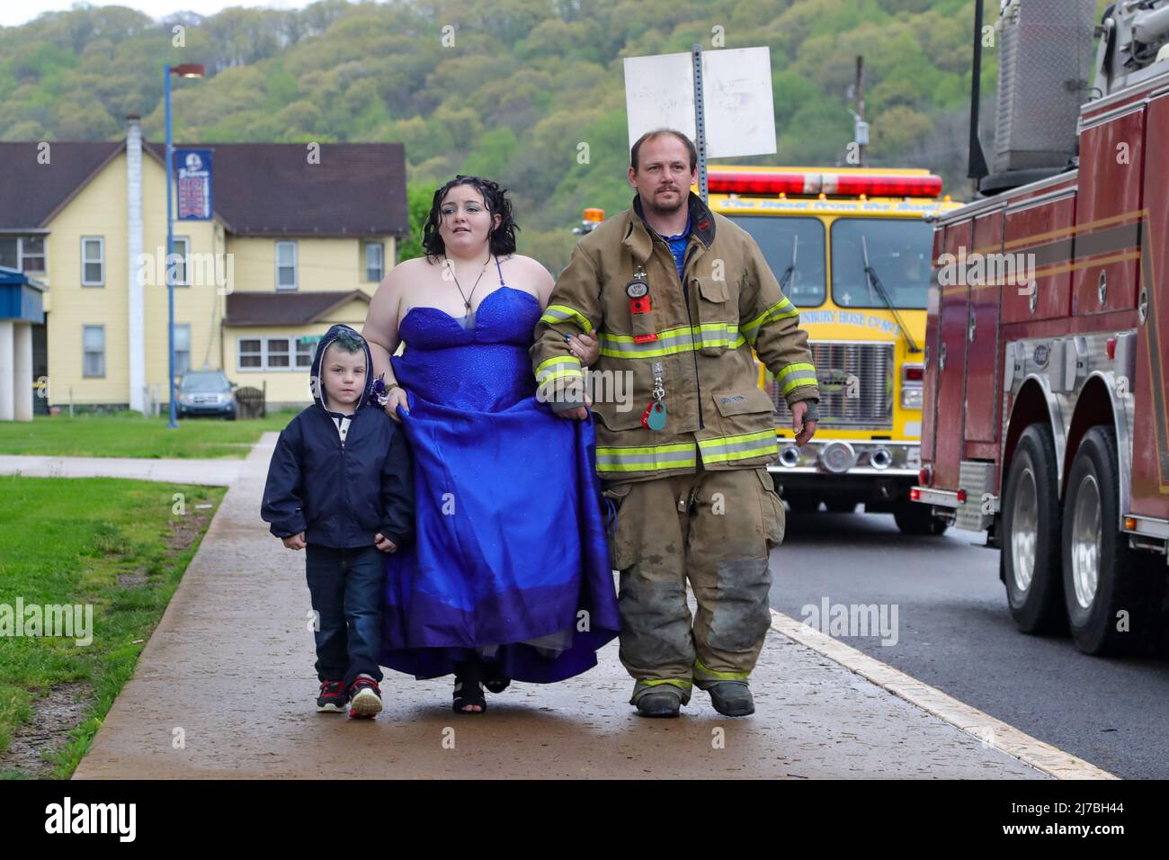 A student arrives at the Shikellamy High School Prom Walk escorted by a ...