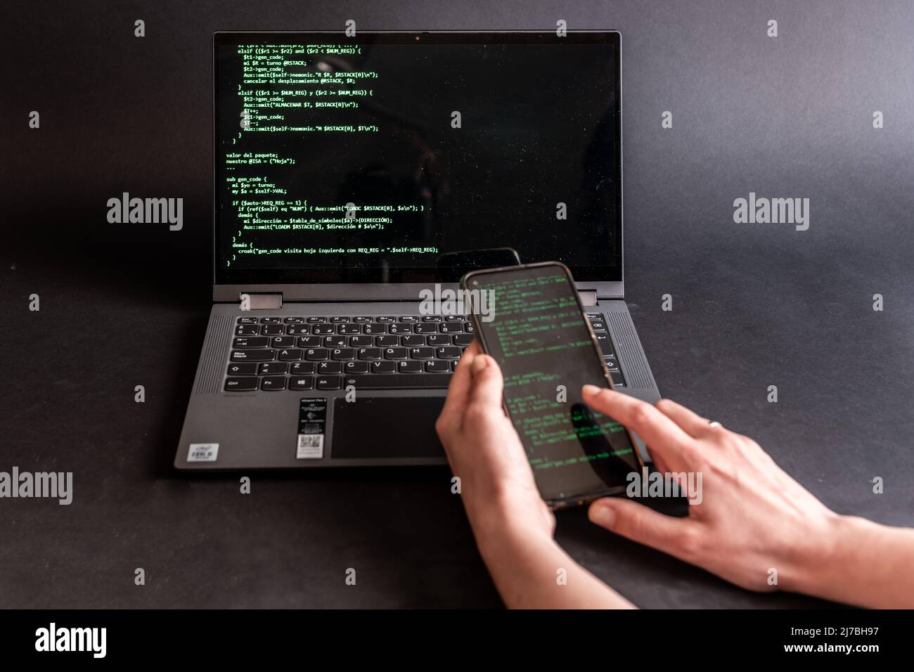 Person with computer and mobile phone hacking with the PEGASUS program ...