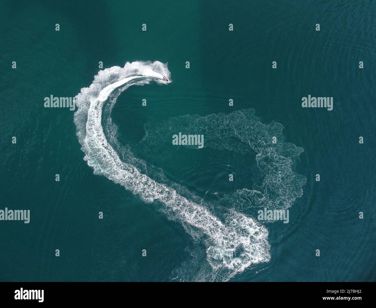 Aerial top down view of water foam trace with nice deep blue shade of ...