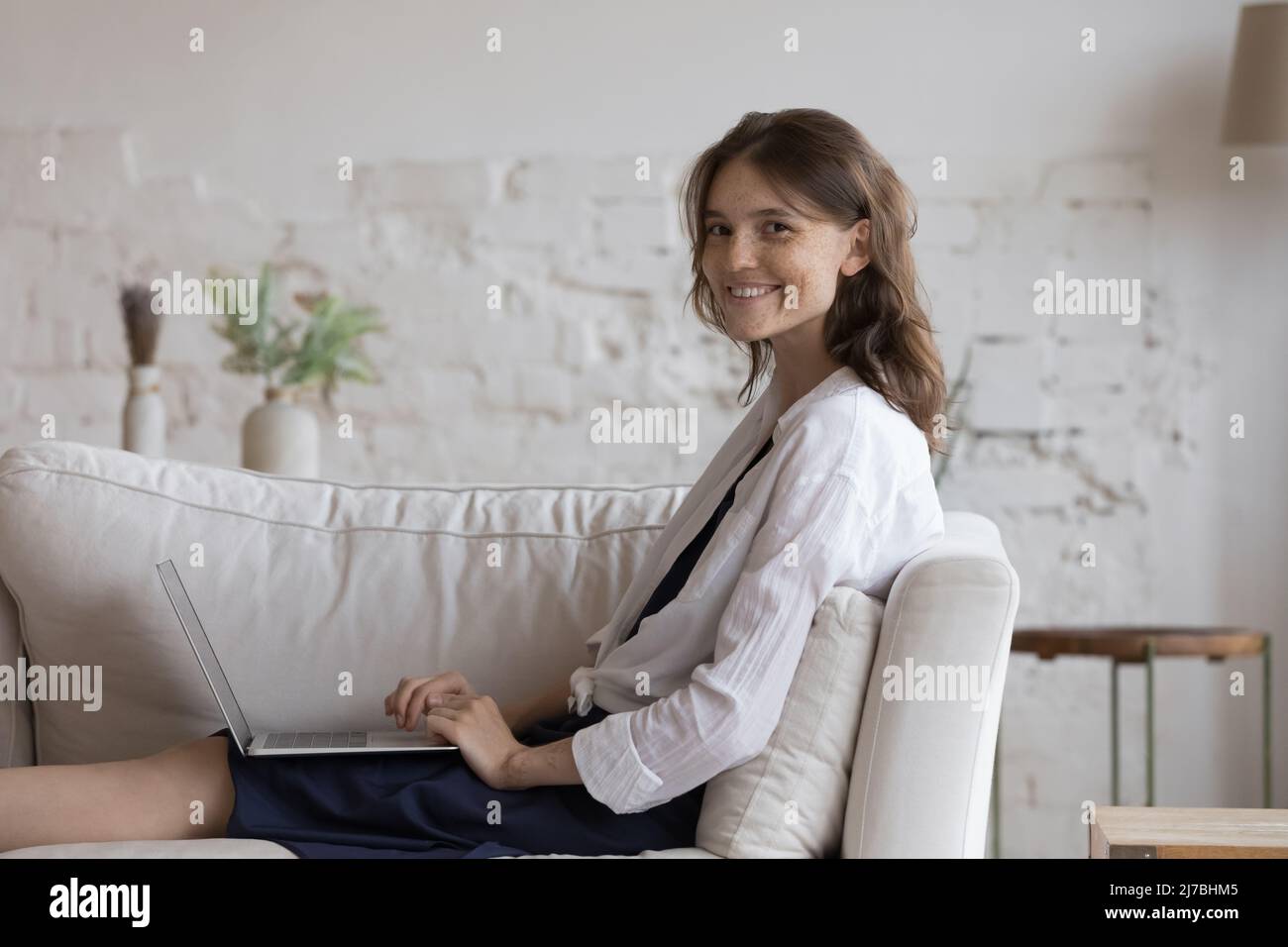 Happy student girl studying from home resting on couch Stock Photo - Alamy