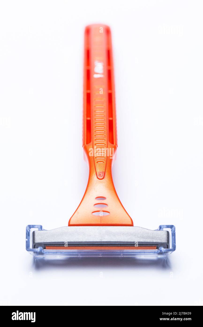 Orange Razor for shaving over white background Stock Photo - Alamy