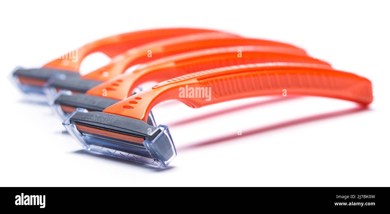 Orange razors for shaving over white background Stock Photo - Alamy