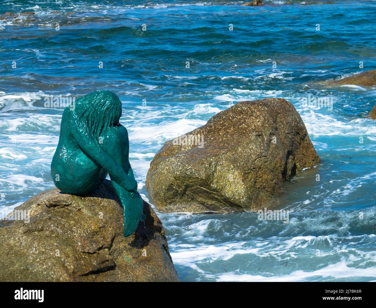 Bronze mermaid sculpture called Sirenella di L'Isula Rossa sitting on a ...