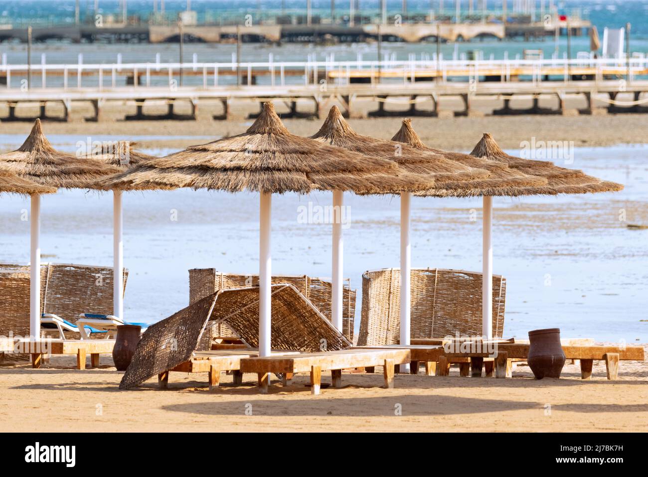 Empty beach in Egypt. Loungers and jetties without people. Holidays in ...