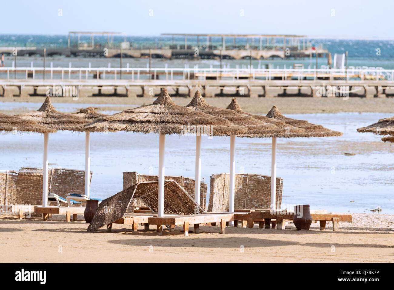 Empty beach in Egypt. Loungers and jetties without people. Holidays in ...