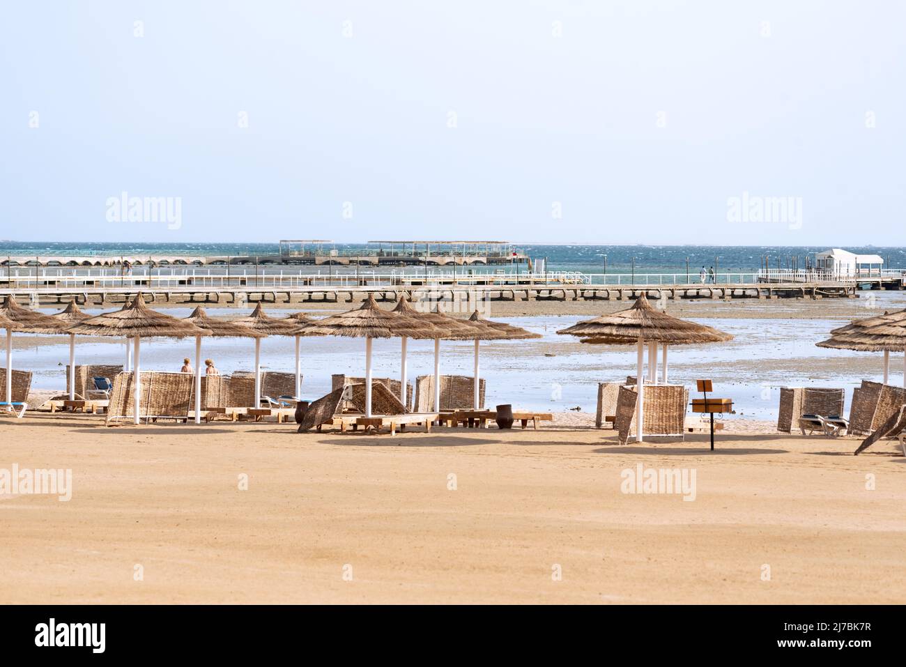 Empty beach in Egypt. Loungers and jetties without people. Holidays in ...