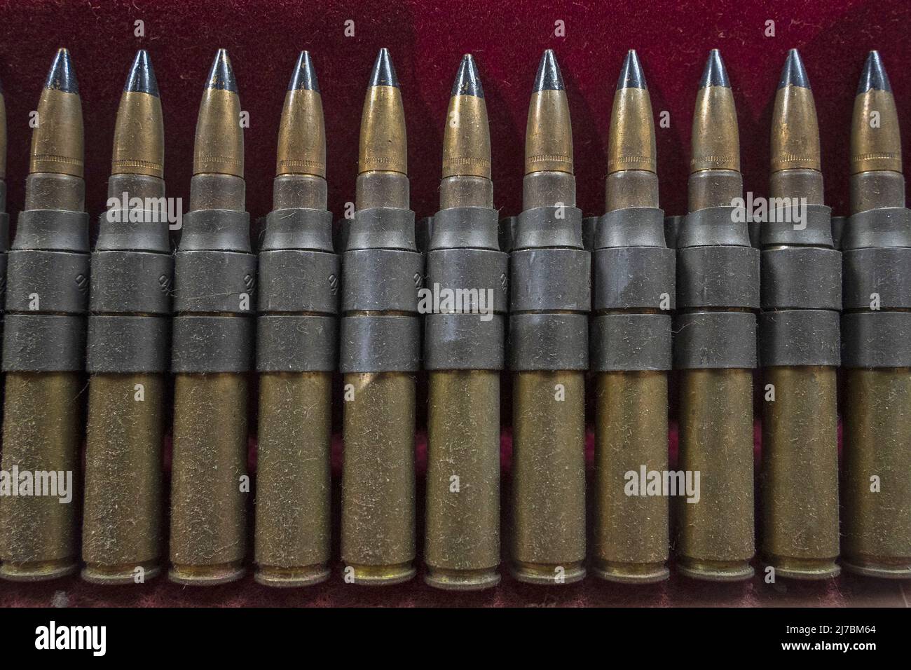 many war gun bullets close up detail on red background Stock Photo - Alamy