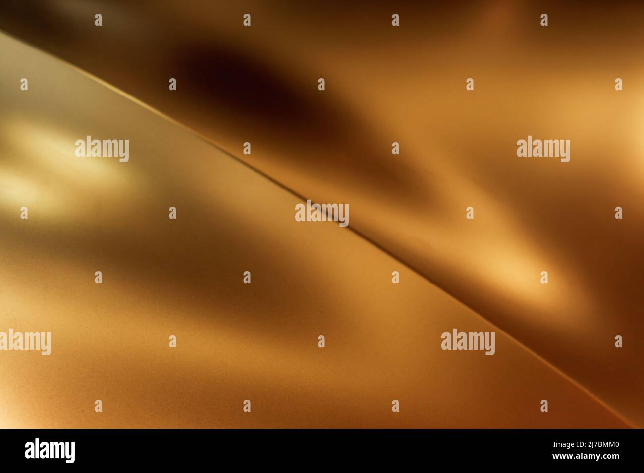 Gold or bronze matte metallic texture with a diagonal bend and ...