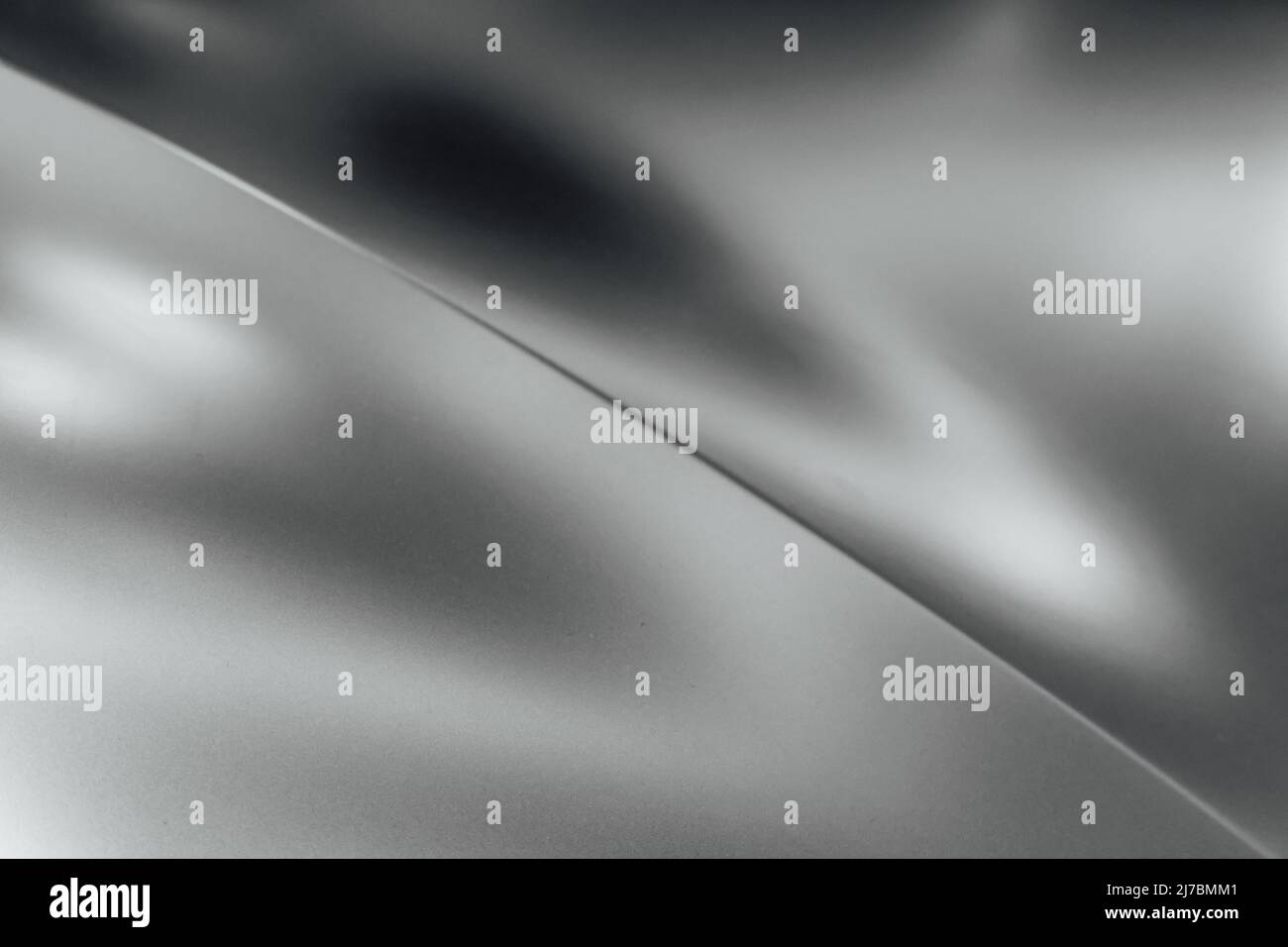 Silver matte metallic texture with a diagonal bend and reflections ...