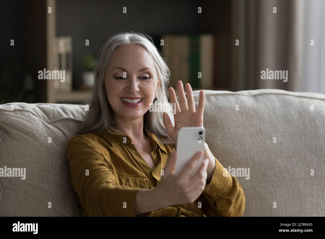 Happy mature retired 50s grandma woman waving hand hello Stock Photo ...