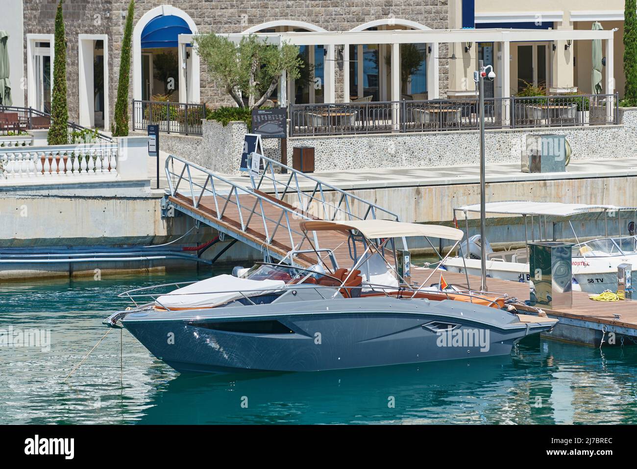 Small yacht of gray color moored at dock Stock Photo - Alamy