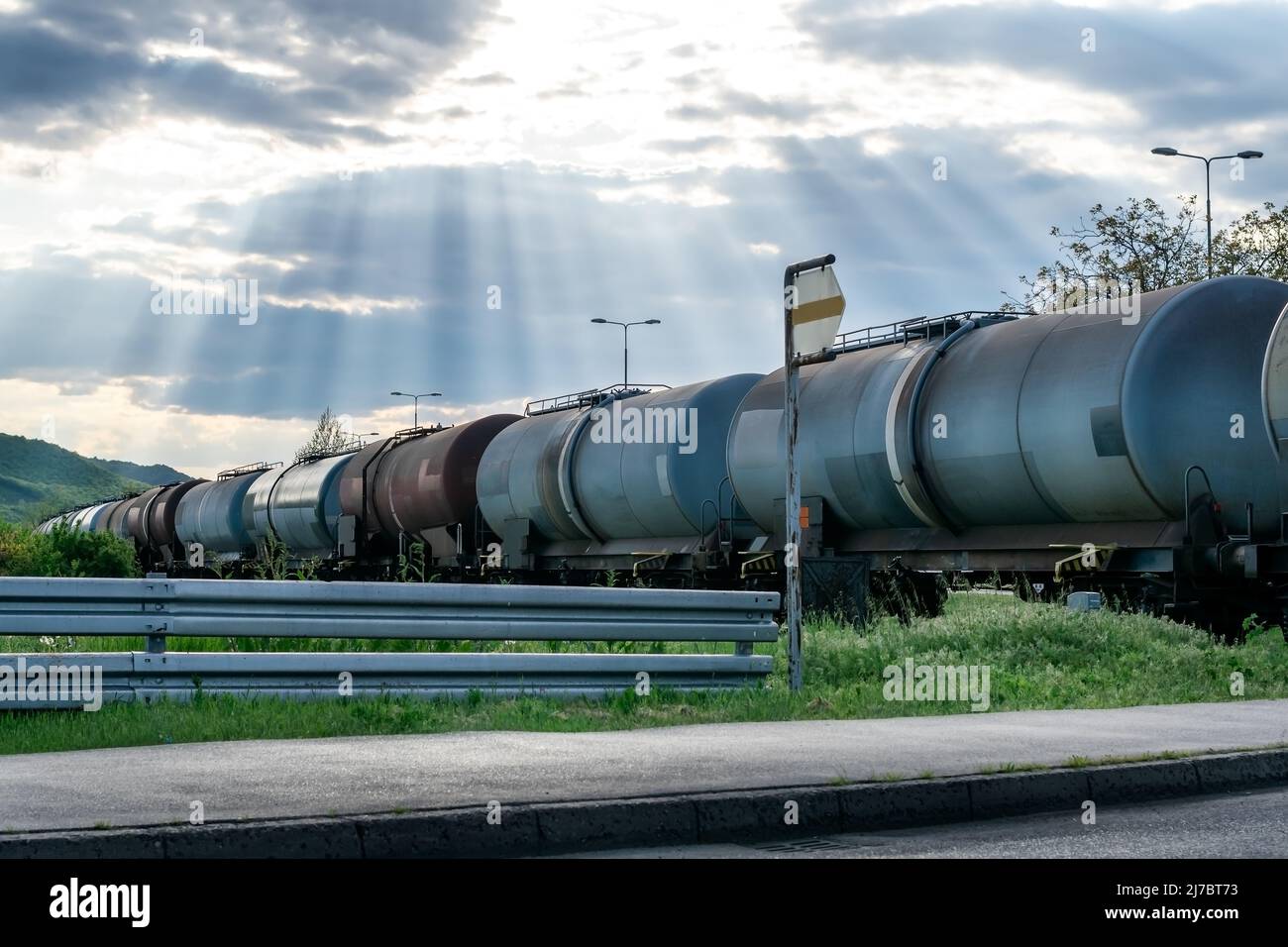 Railroad train of tanker cars transporting crude oil on the tracks ...