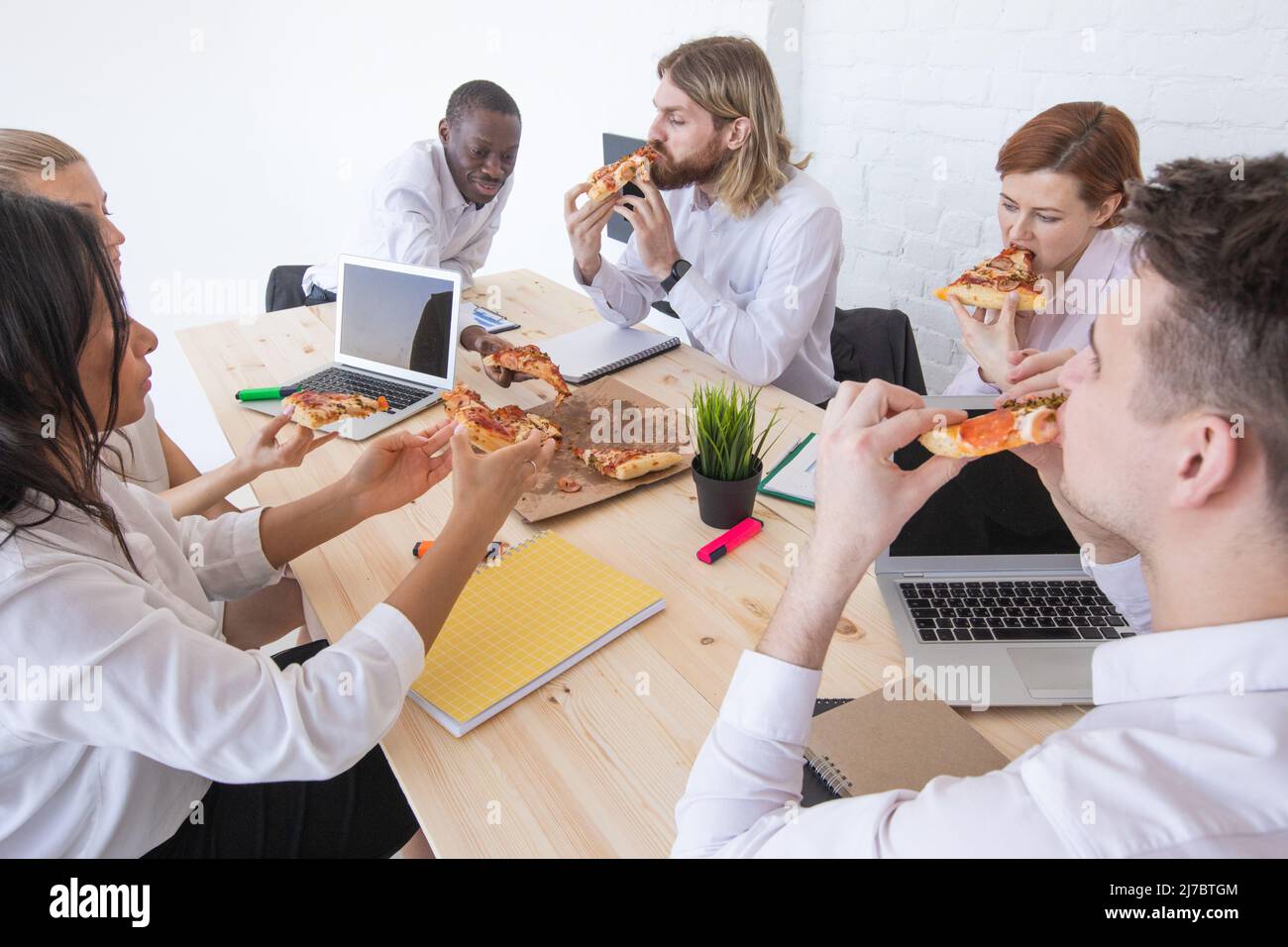 Diverse Business Team People Workers Eating Pizza Together At Workplace
