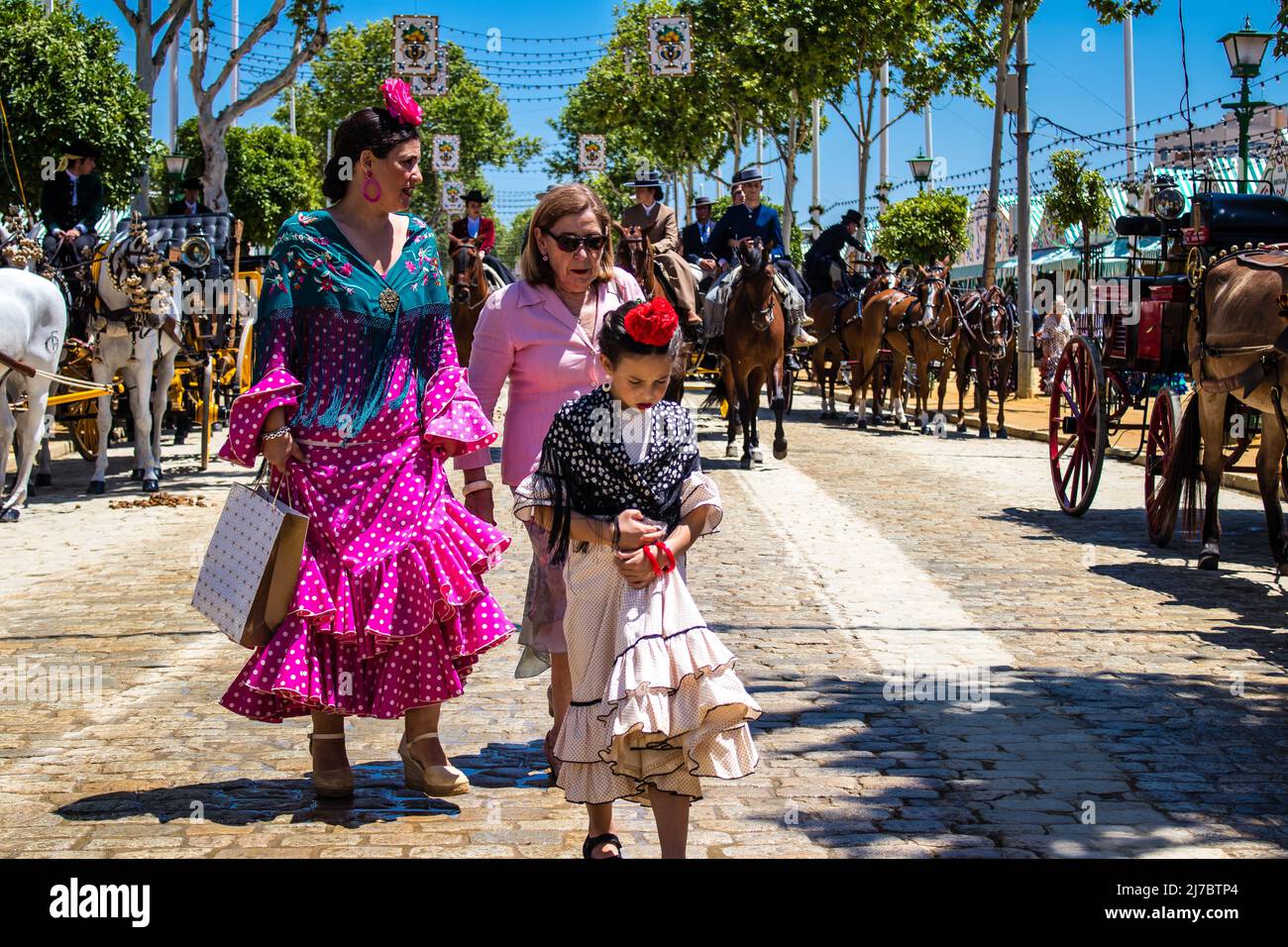 Seville, Spain - May 05, 2022 Sevillians dressed in traditional ...