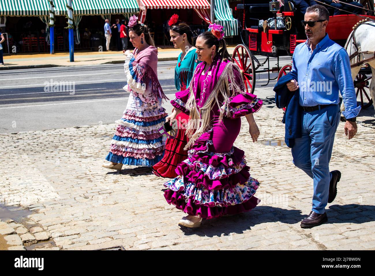 Seville, Spain - May 05, 2022 Sevillians dressed in traditional ...