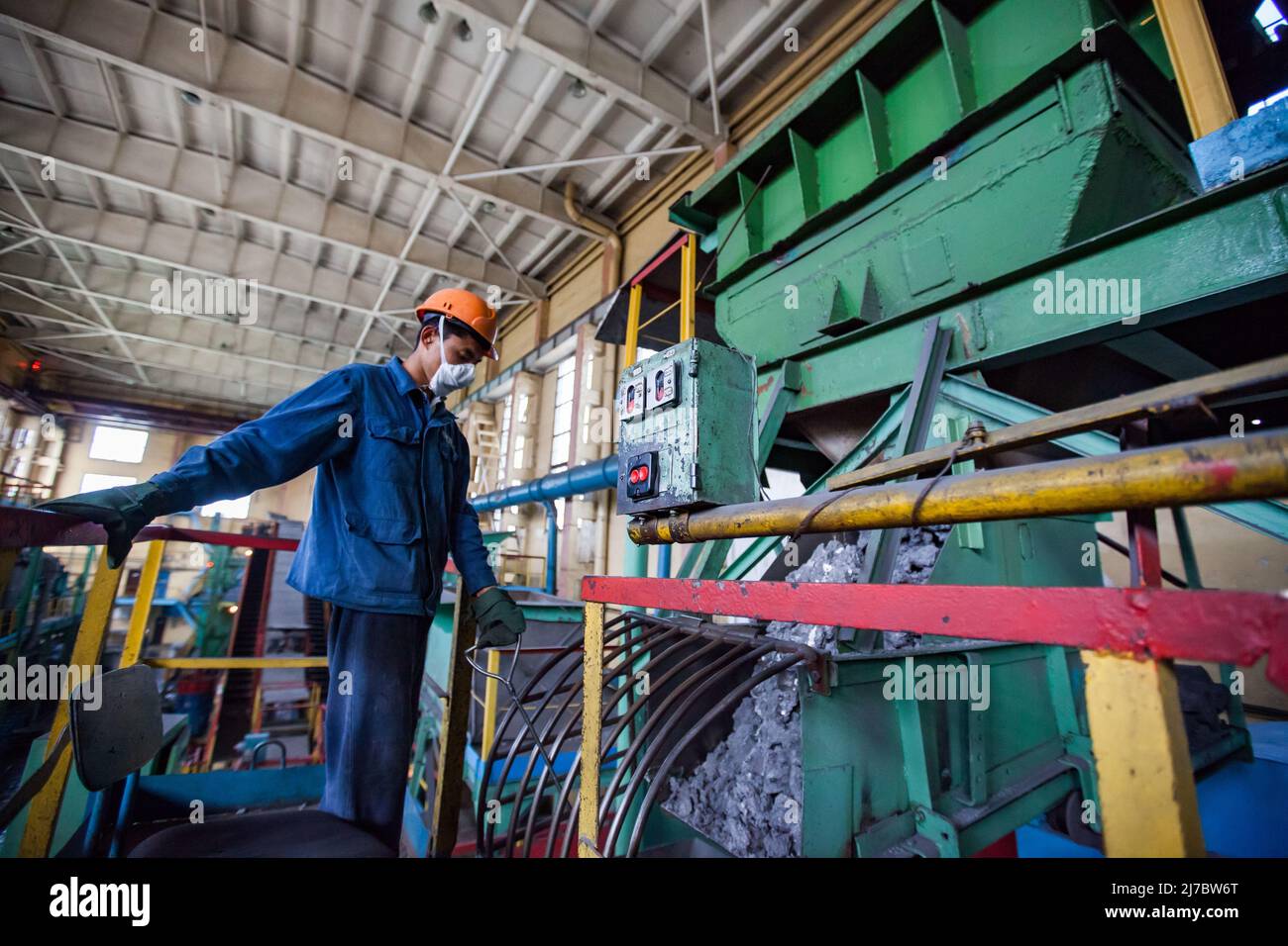 Ust'-Kamenogorsk, Kazakhstan - May 31, 2012: young Asian worker in blue ...