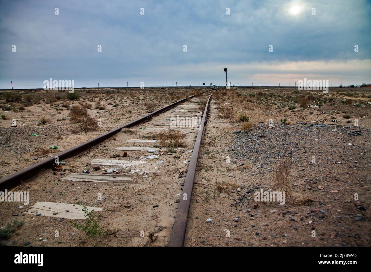 Abandoned railroad line in desert. Rusted rails and wooden sleepers ...