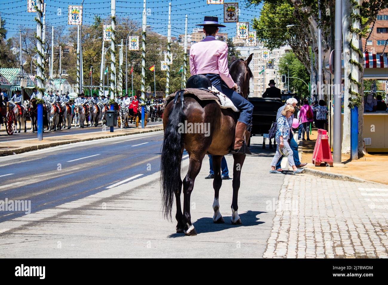 Seville, Spain - May 05, 2022 Sevillian riders dressed in the ...