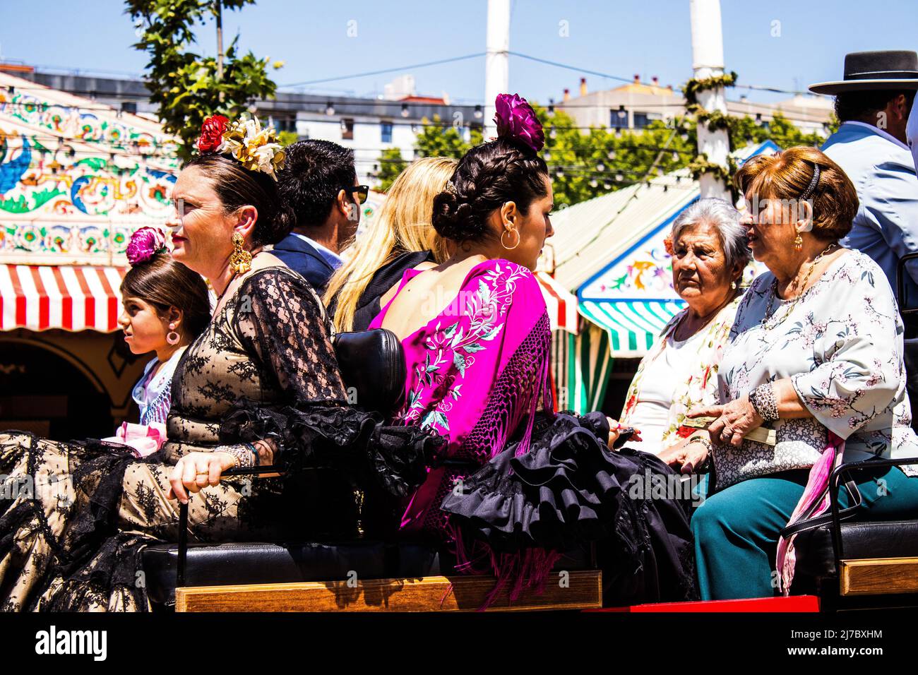 Seville, Spain - May 05, 2022 Sevillians dressed in the traditional ...