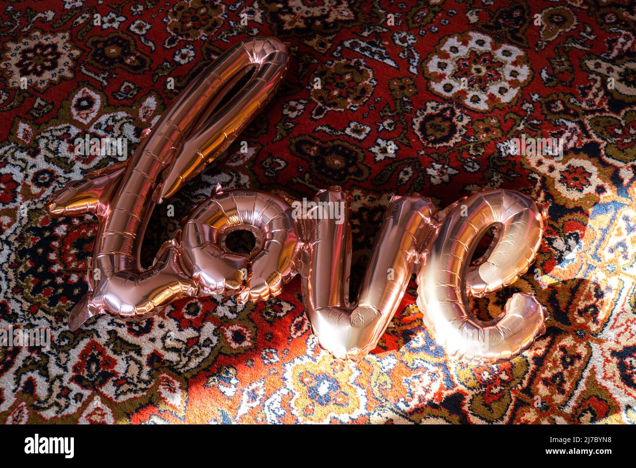 Love text pink foil balloon on authentic Love word from pink inflatable ...