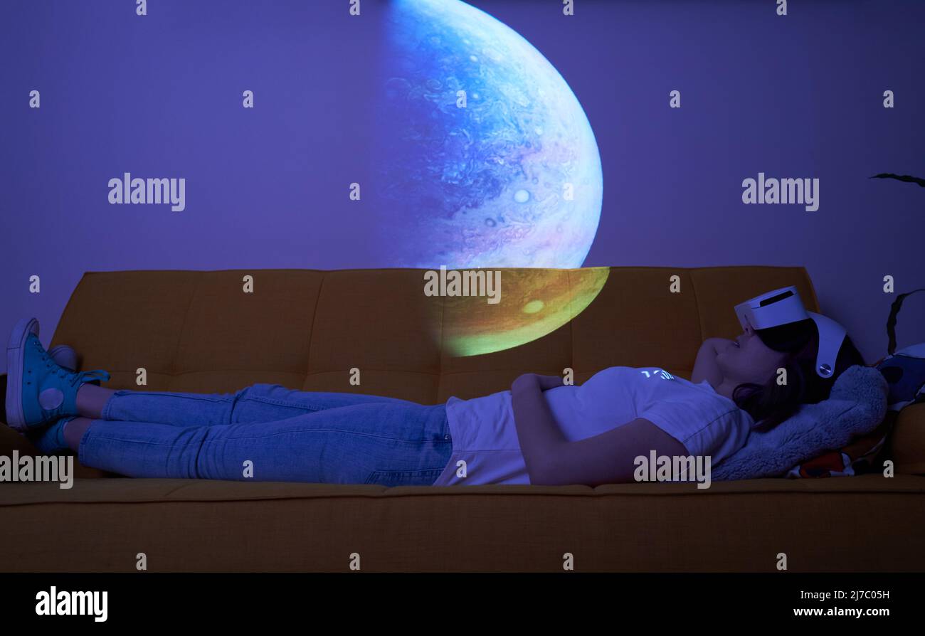 Woman uses virtual reality glasses to see the galaxy space. Elements of ...