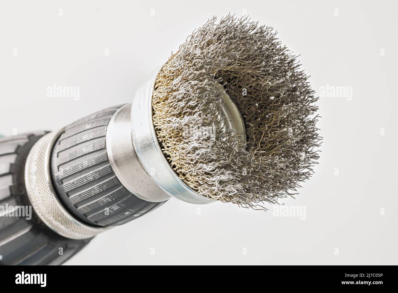 Hand drill with round steel brush on white background Stock Photo - Alamy
