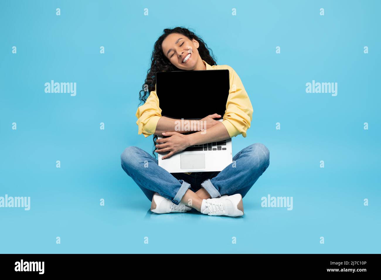 Technology Lover. Excited woman hugging laptop at studio Stock Photo ...