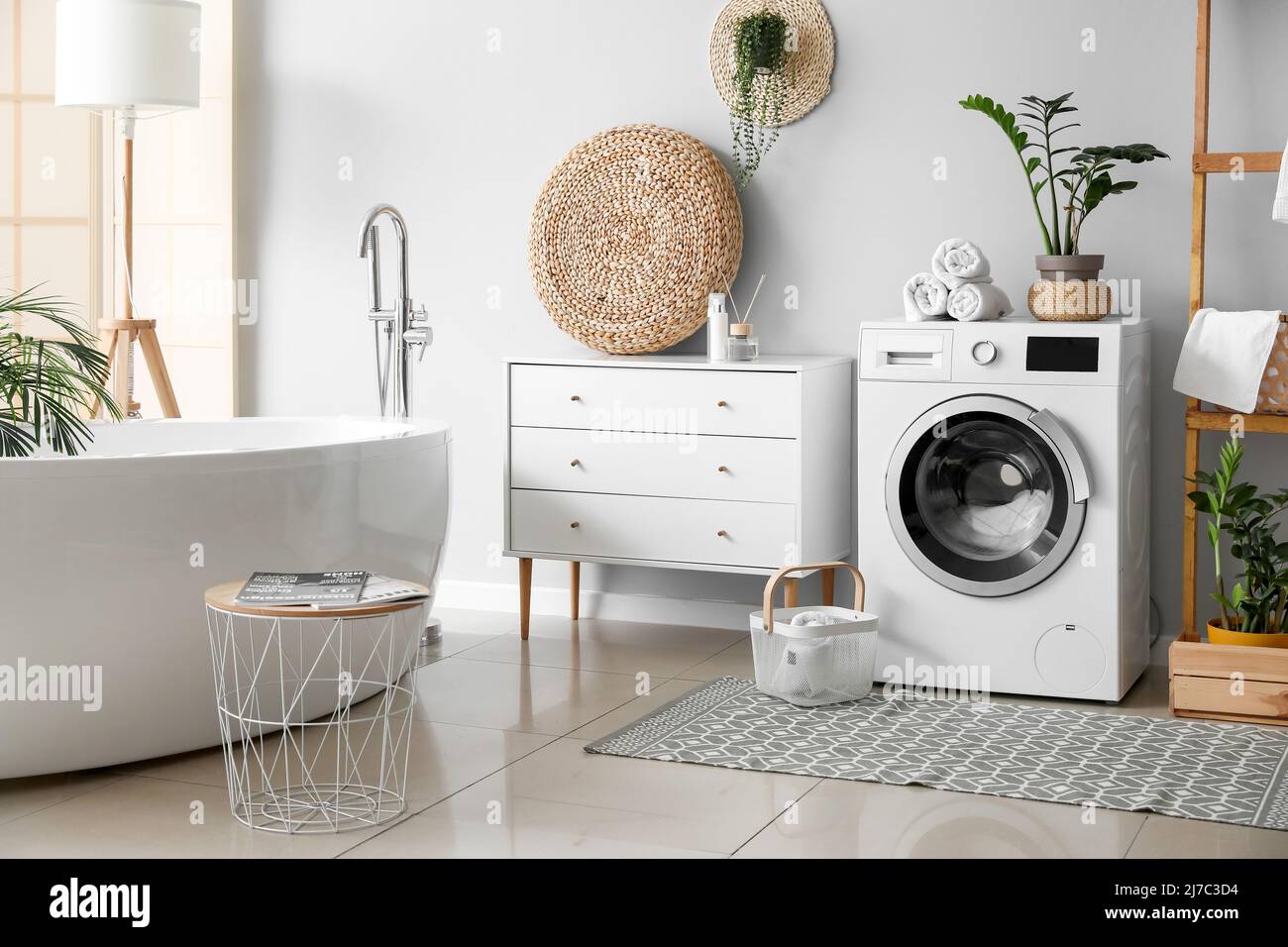 Interior of stylish bathroom with modern washing machine Stock Photo ...